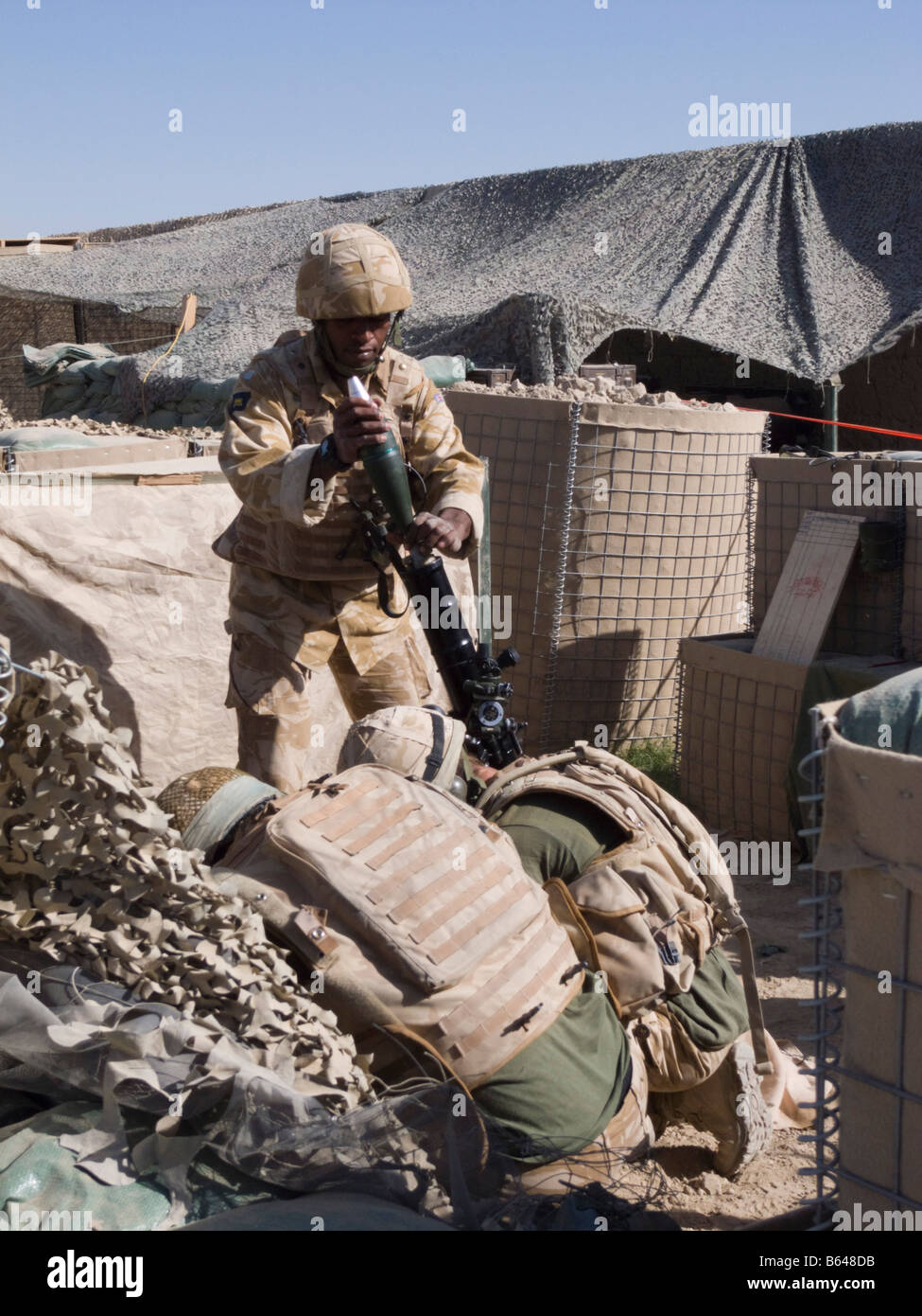 British Army soldiers with helmet and body armour firing 81mm mortar in ...
