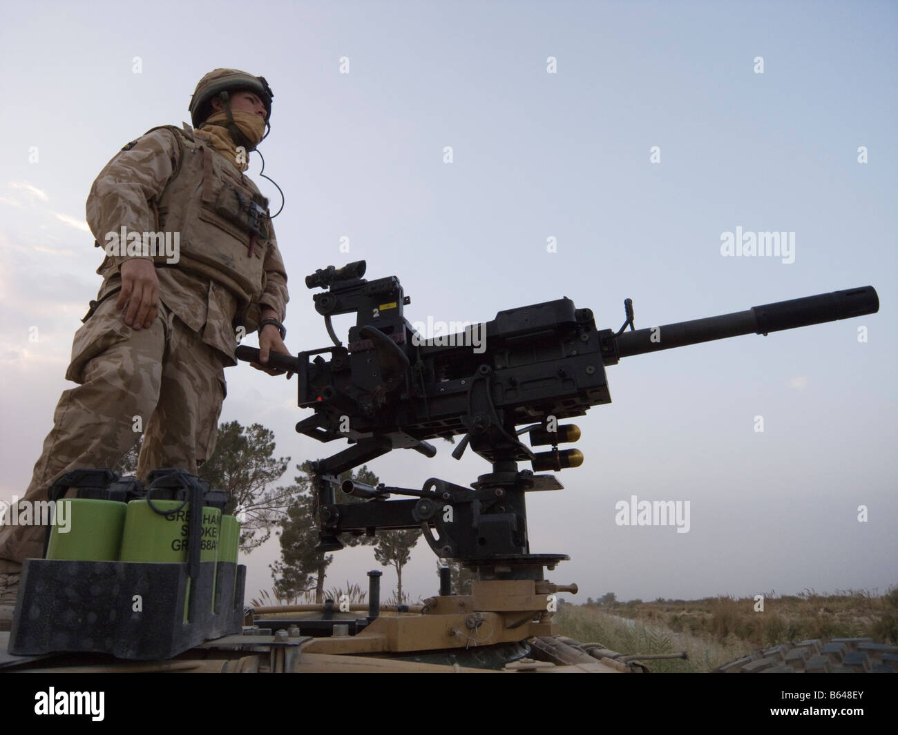 British Army soldier looks out with Grenade Machine Gun Stock Photo - Alamy