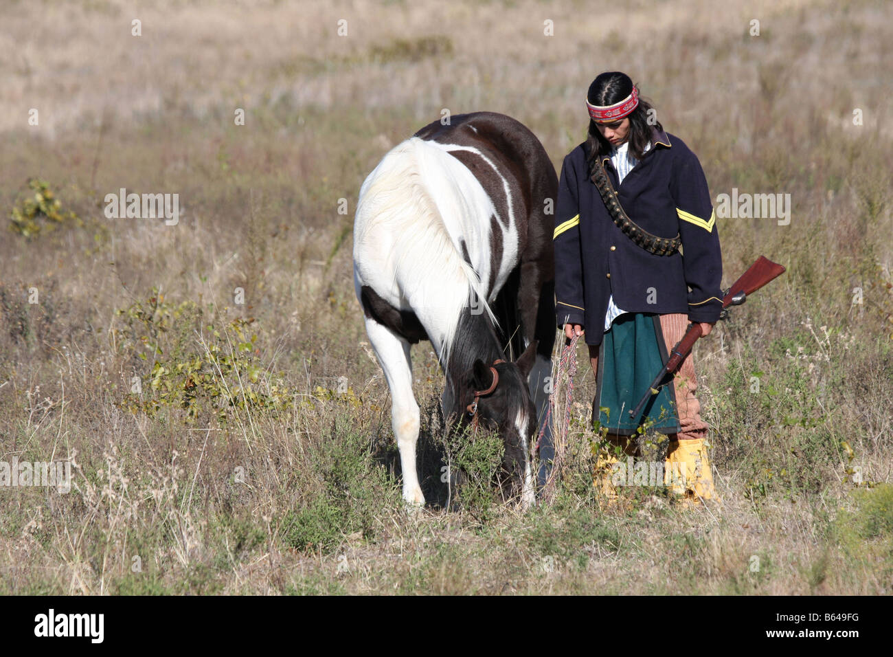 An Apache Native American Indian letting his horse eat grass Stock ...