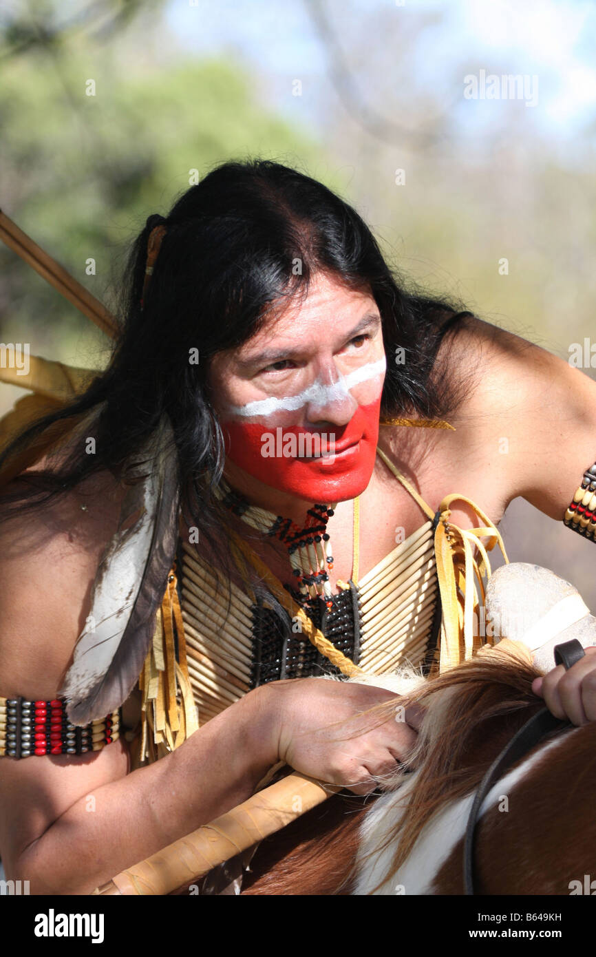 An Apache Native American Indian man on top of a horse in cover ...