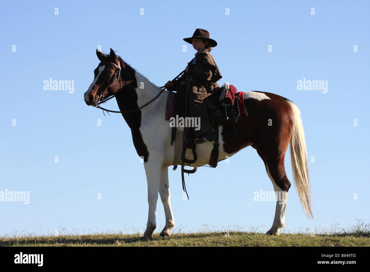A young cowboy on horseback ready to work the ranch Stock Photo - Alamy