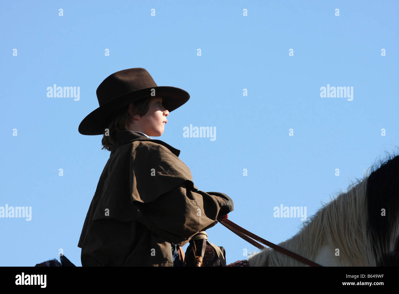 A young cowboy on horseback working the ranch Stock Photo - Alamy