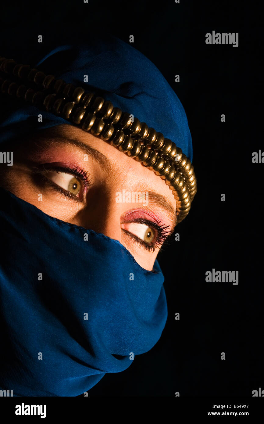 Young woman with decorative headress and yashmak type veil covering her ...
