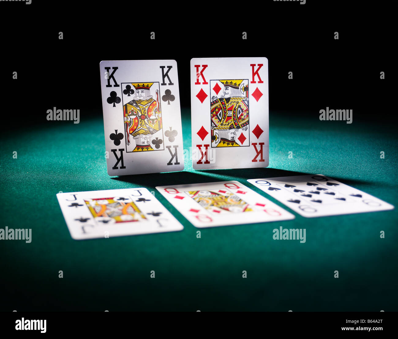2 kings standing up over 3 cards Stock Photo - Alamy
