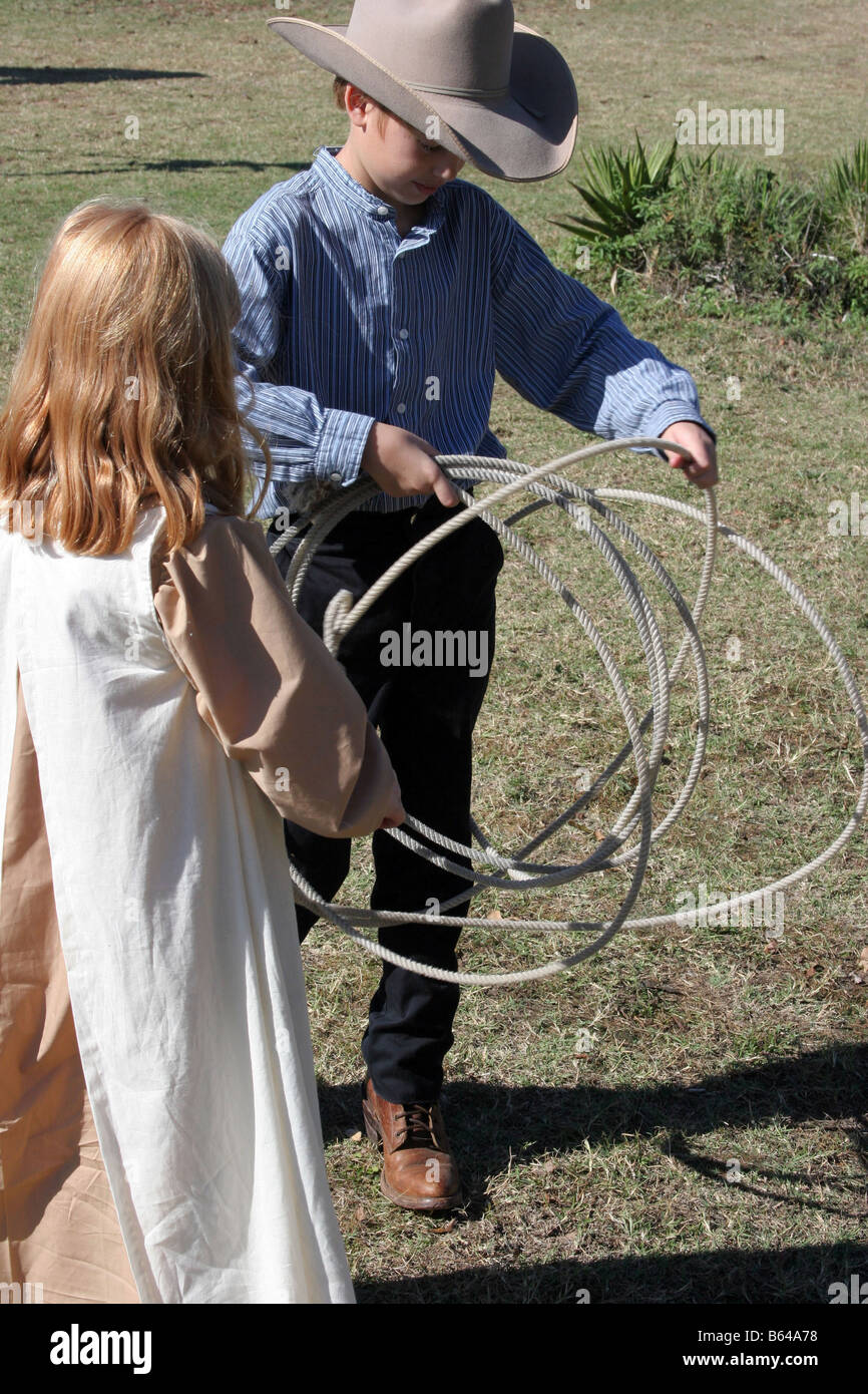 A young cowboy showing a little girl how to twirl the rope Stock Photo ...