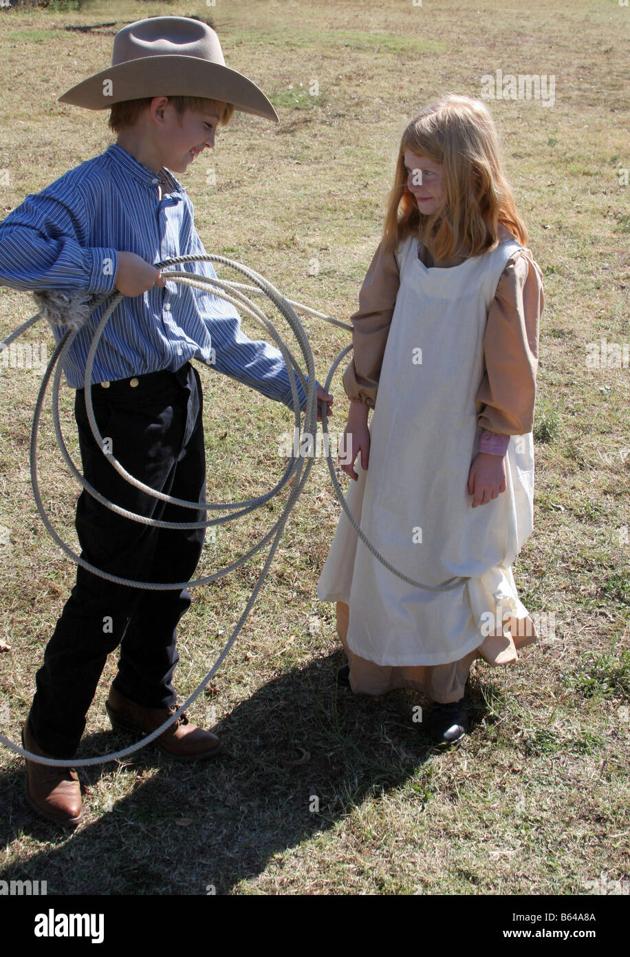 A young cowboy who has roped a cute young girl Stock Photo - Alamy