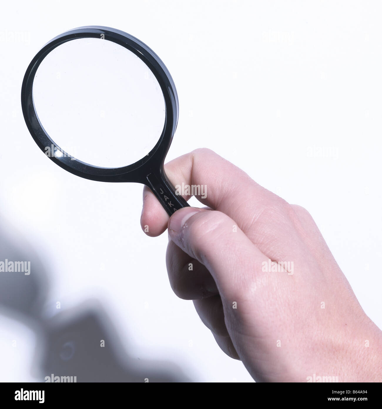 male hand holding magnifying glass Stock Photo - Alamy