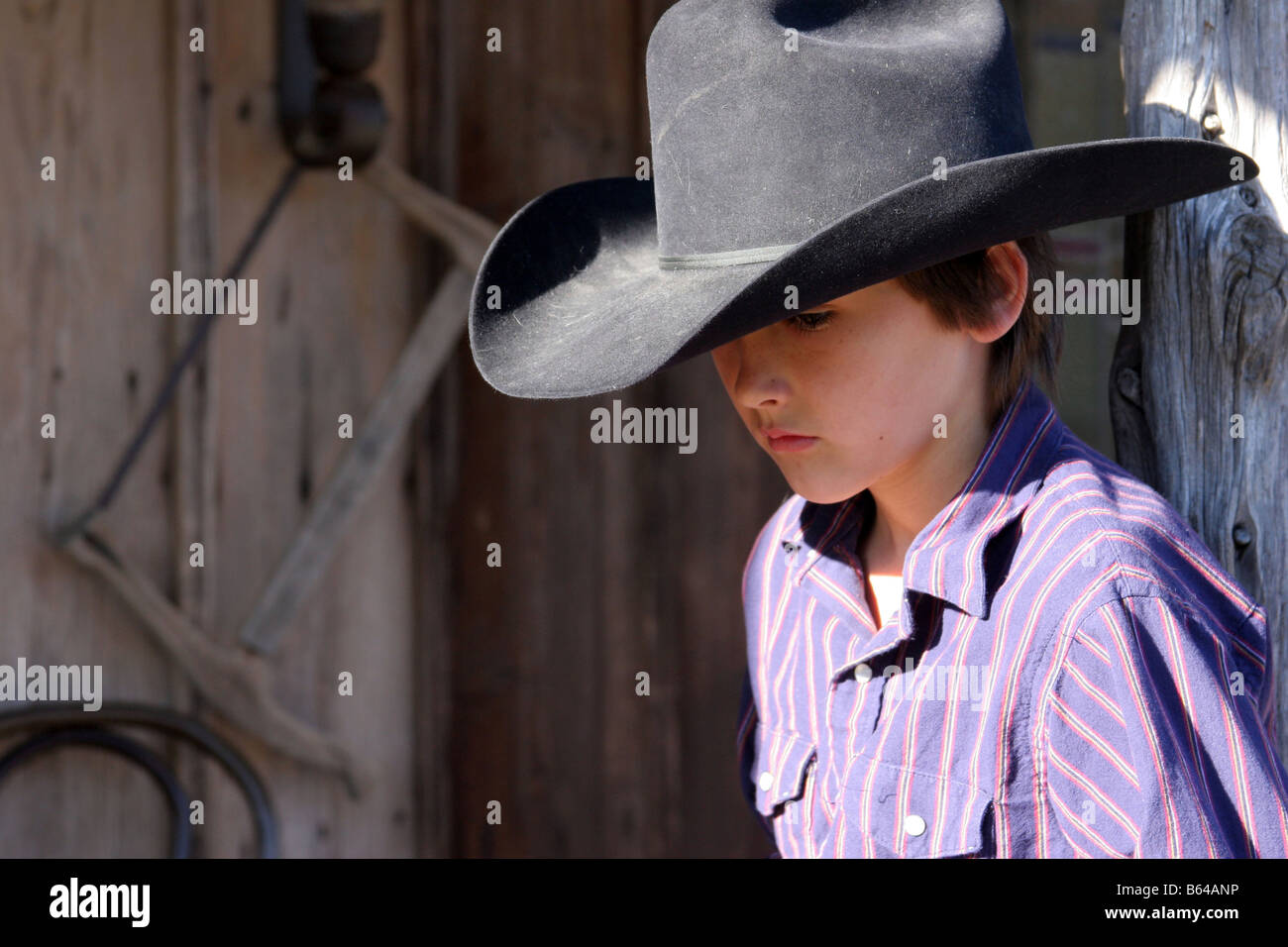 A young cowboy on the ranch in the old west Stock Photo - Alamy