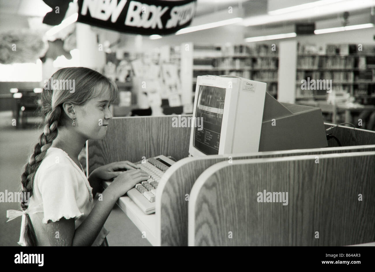 Young female student reading,doing research on computer, studing in ...