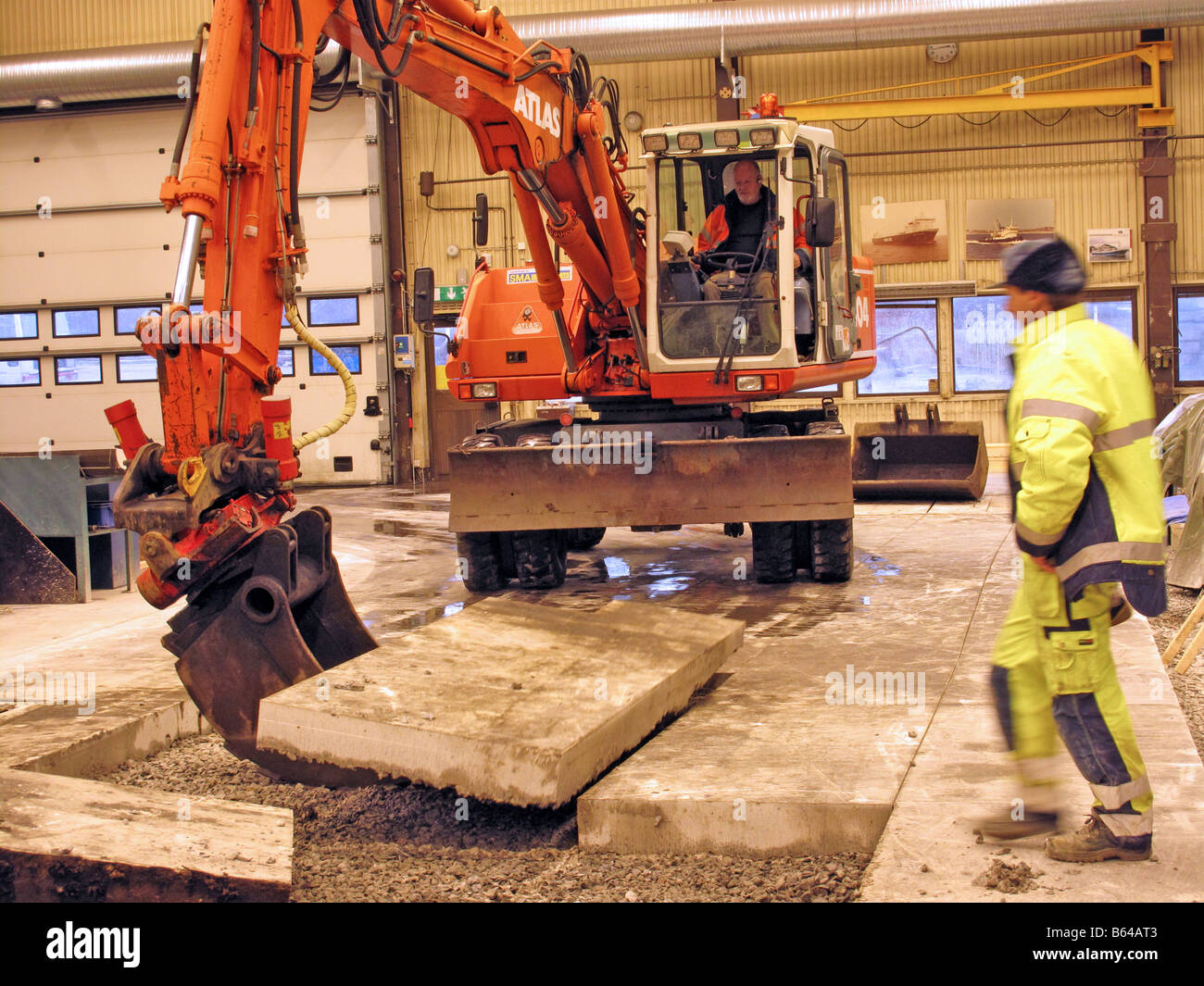 Concrete floor demolition with excavator Stock Photo - Alamy