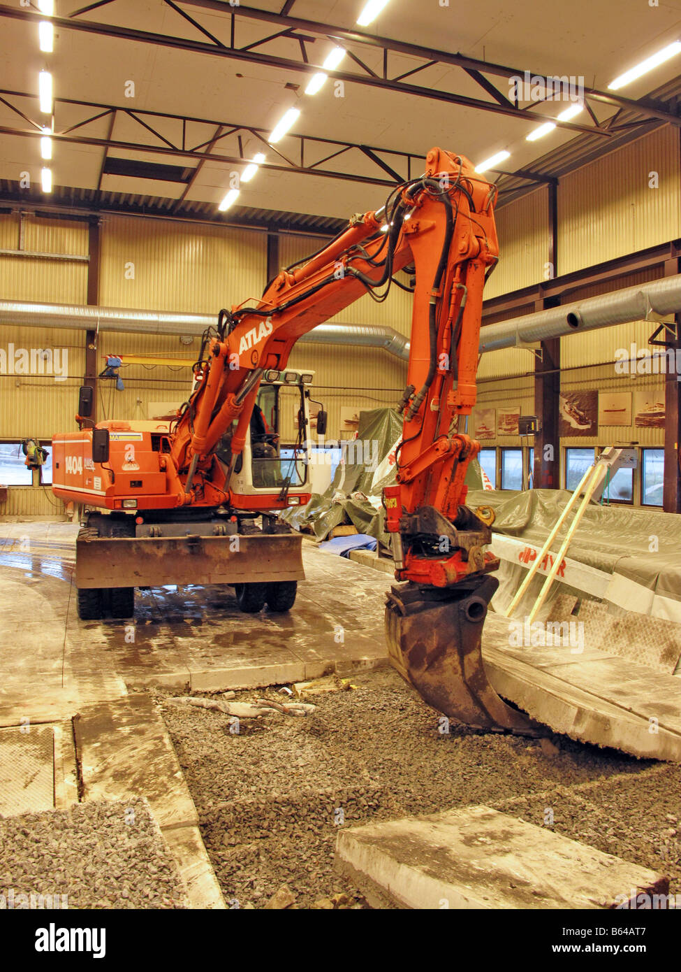 Concrete floor demolition with excavator Stock Photo - Alamy
