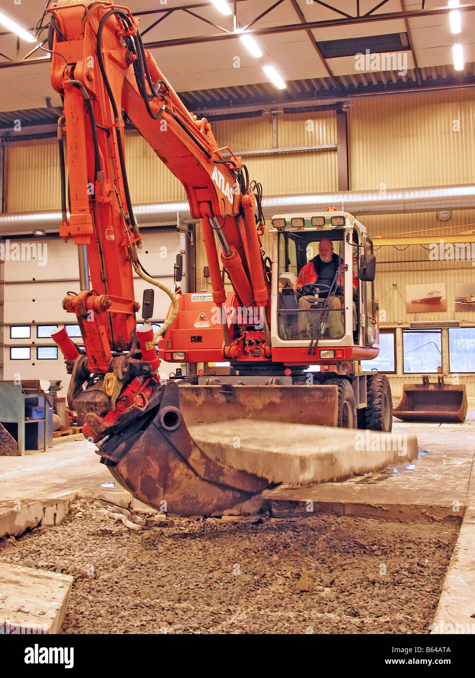 Concrete floor demolition with excavator Stock Photo - Alamy