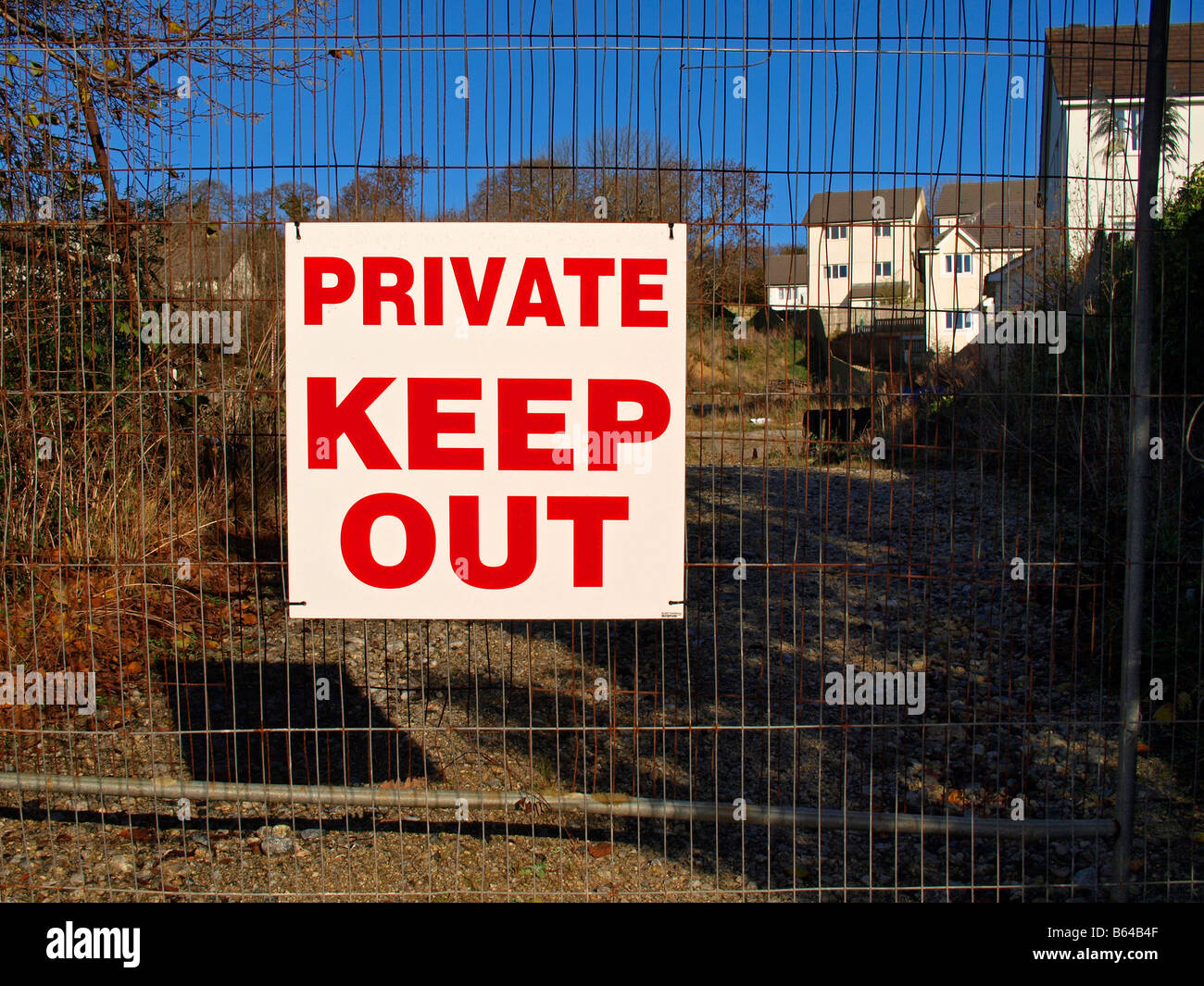 a "private keep out " sign on a wire fence Stock Photo - Alamy