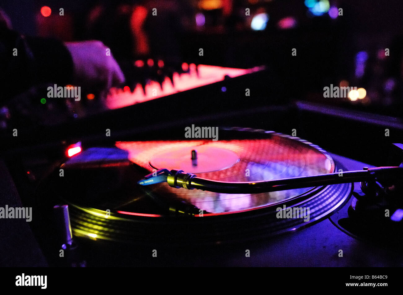Record playing on a deck with a DJ Stock Photo - Alamy