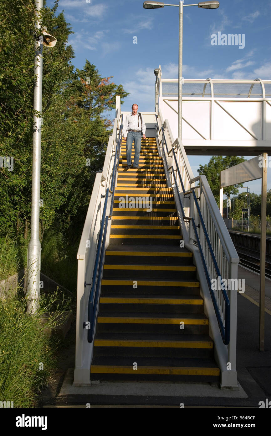 Steps leading to passenger bridge over railway line Stock Photo - Alamy