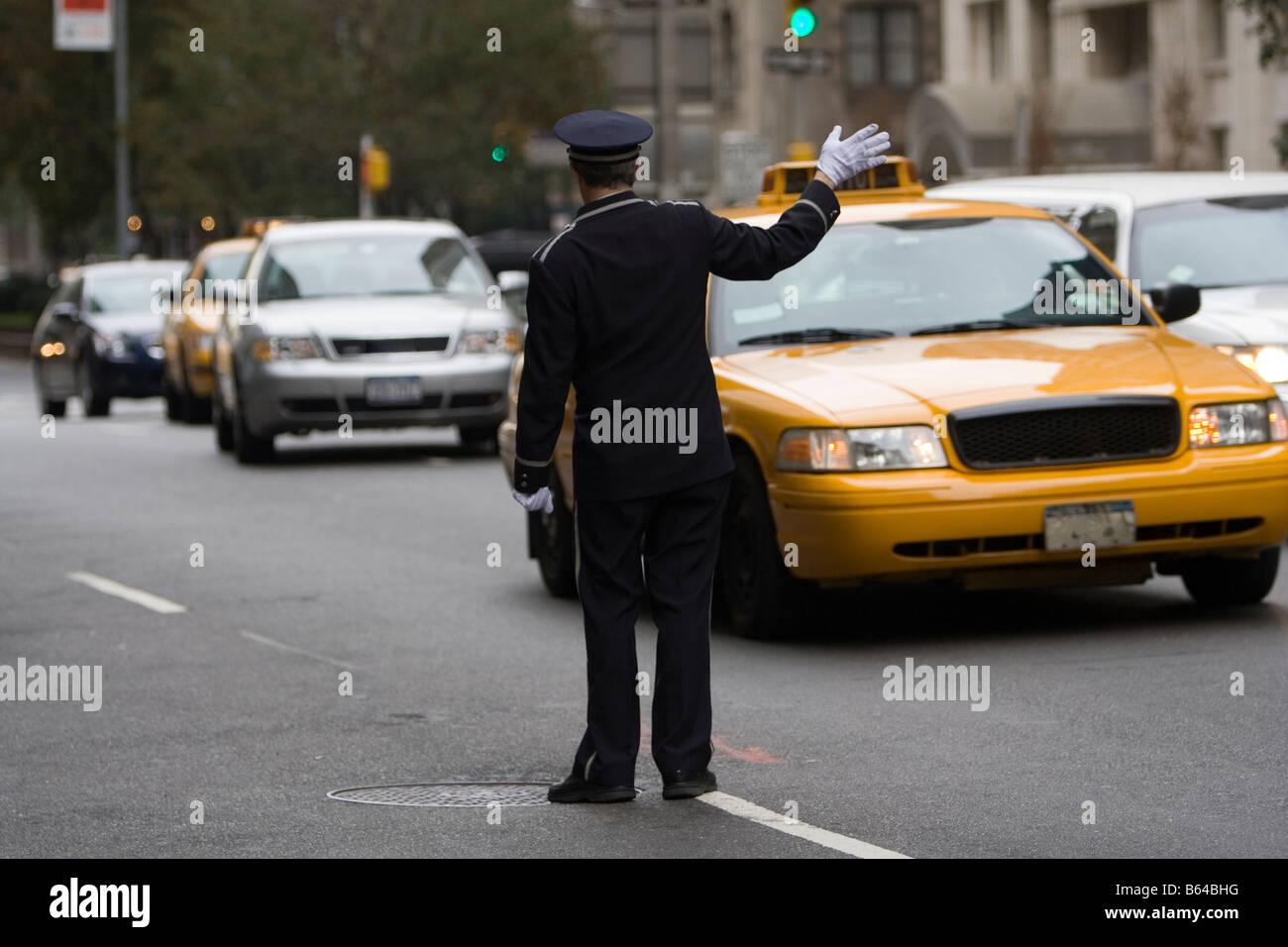 Door Man calling New York City Yellow Taxi. Manhattan NY USA Stock ...