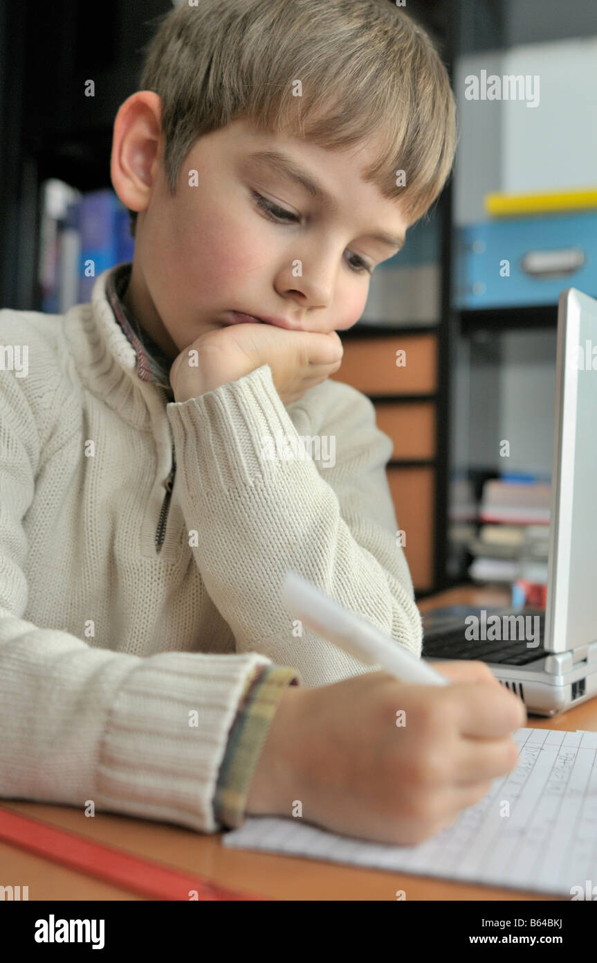 Schoolboy working on his homework Stock Photo - Alamy