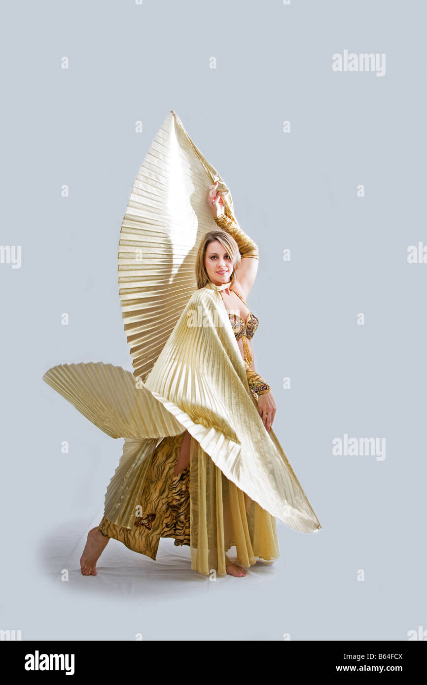 Beautiful belly dancer in gold outfit with wings isolated Stock Photo ...