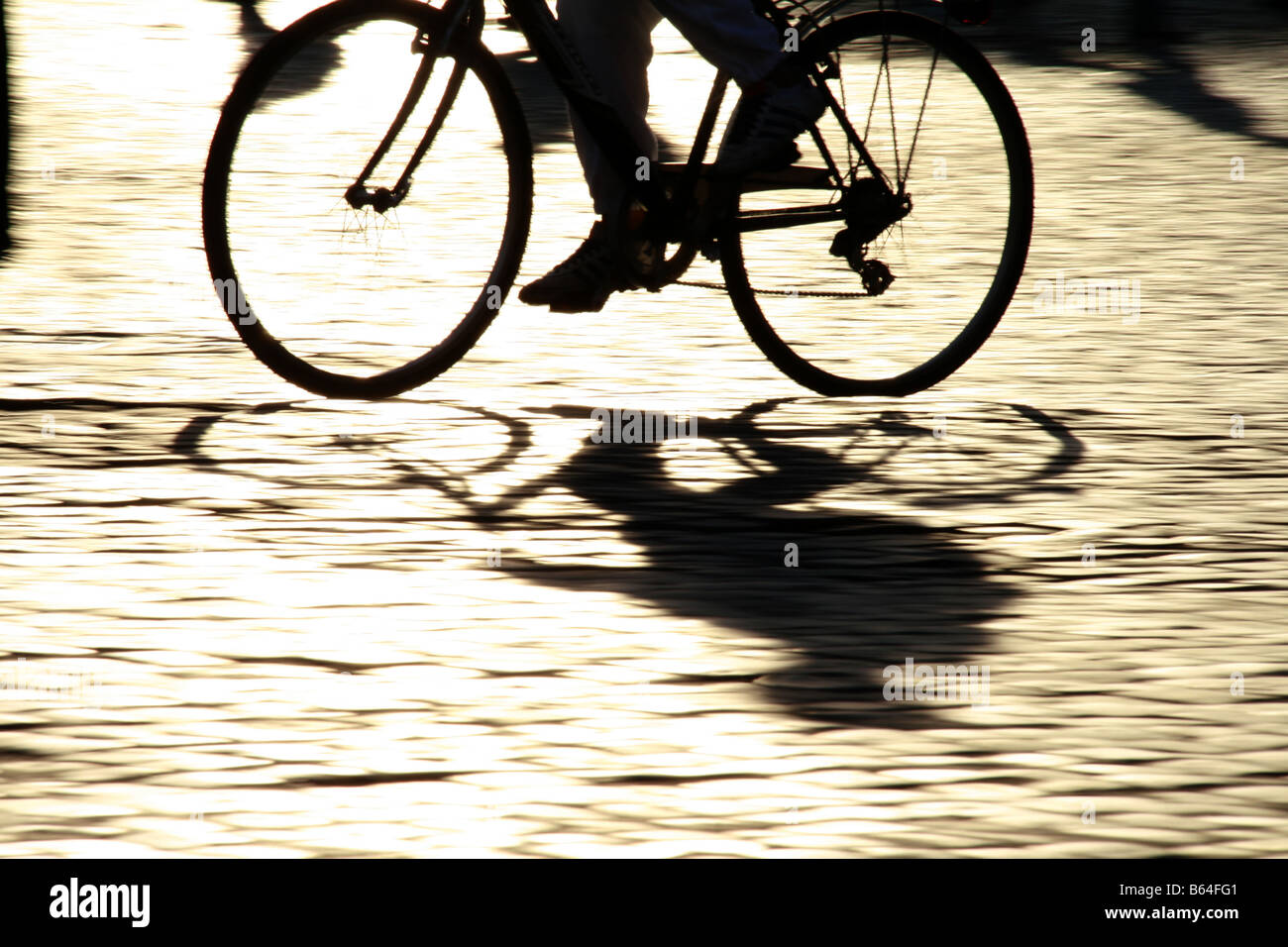 shadow fast speed bike in action in sun in street in town Stock Photo ...