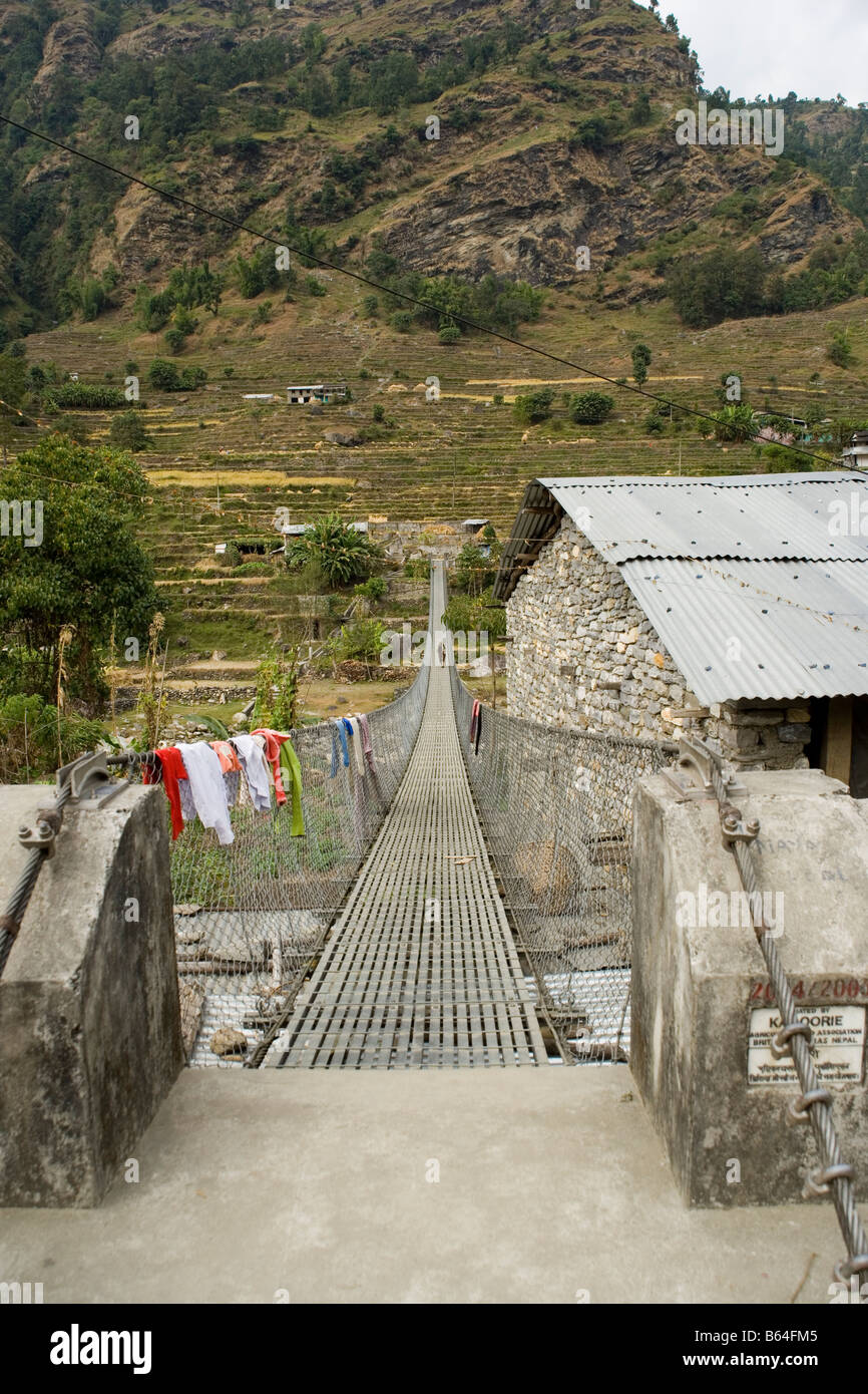 Metal rope bridge crossing the Modi River in the Annapurna range of the ...