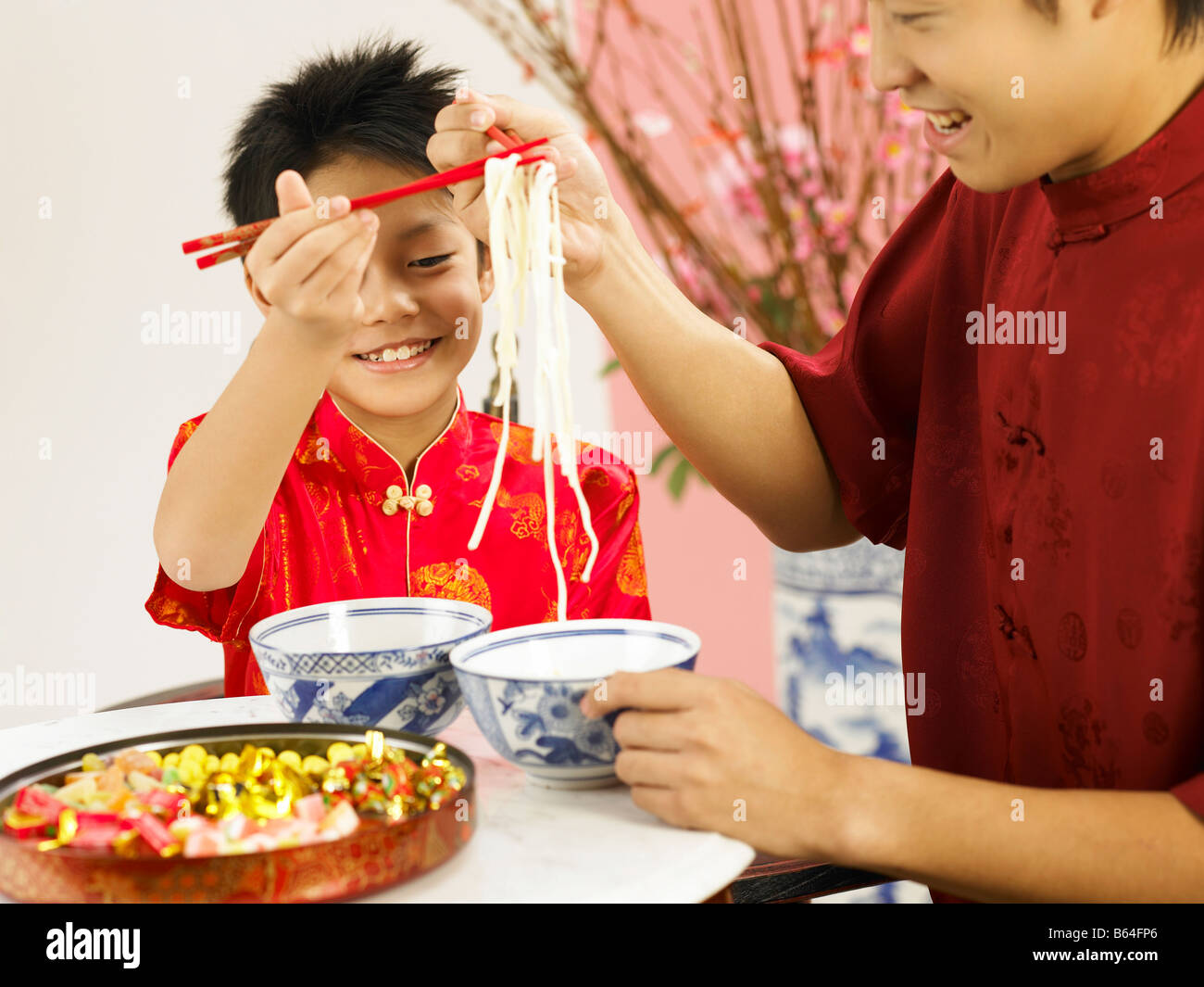 father and son eating longevity noodle during chinese new year Stock ...