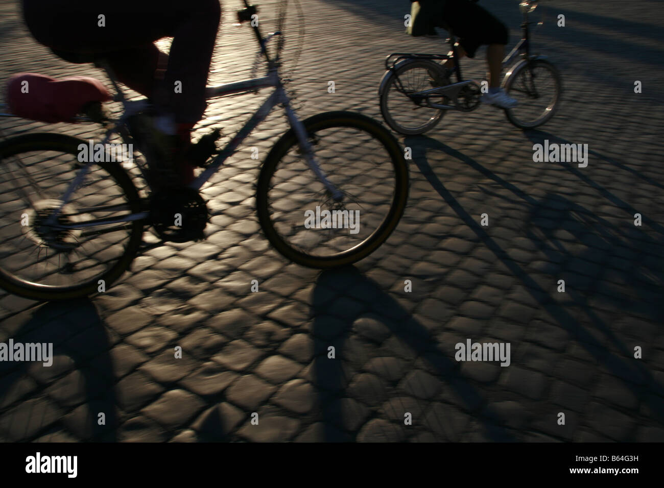 shadow fast speed bikes in action in sun in street in town Stock Photo ...