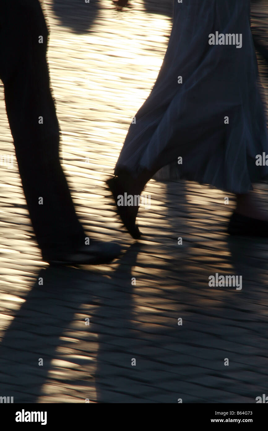 shadow people feet legs walking in street in town Stock Photo - Alamy