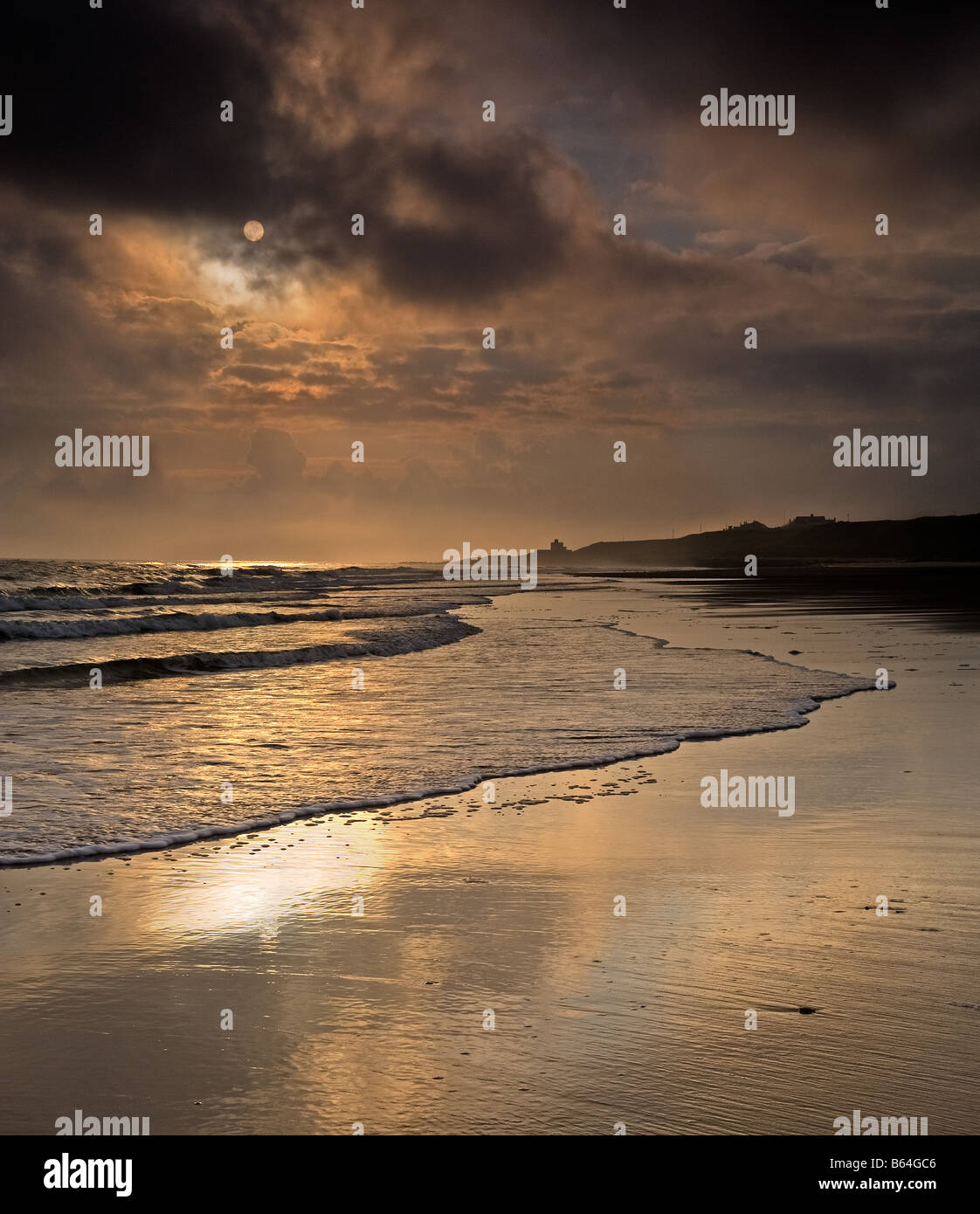 Sunrise over Bamburgh Lighthouse from Budle Bay Northumberland Stock ...