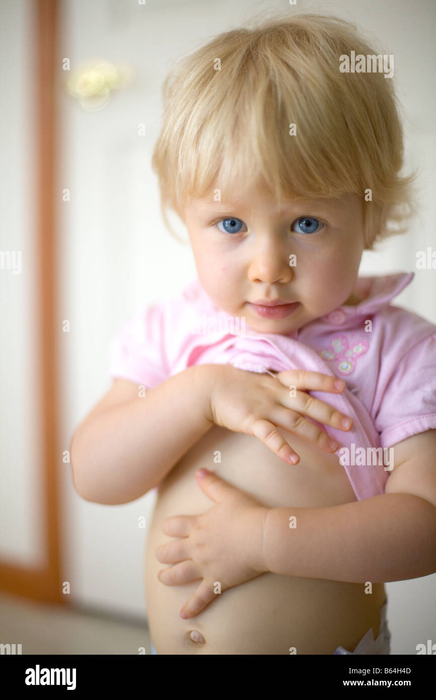 Baby Girl playing with tummy Stock Photo - Alamy
