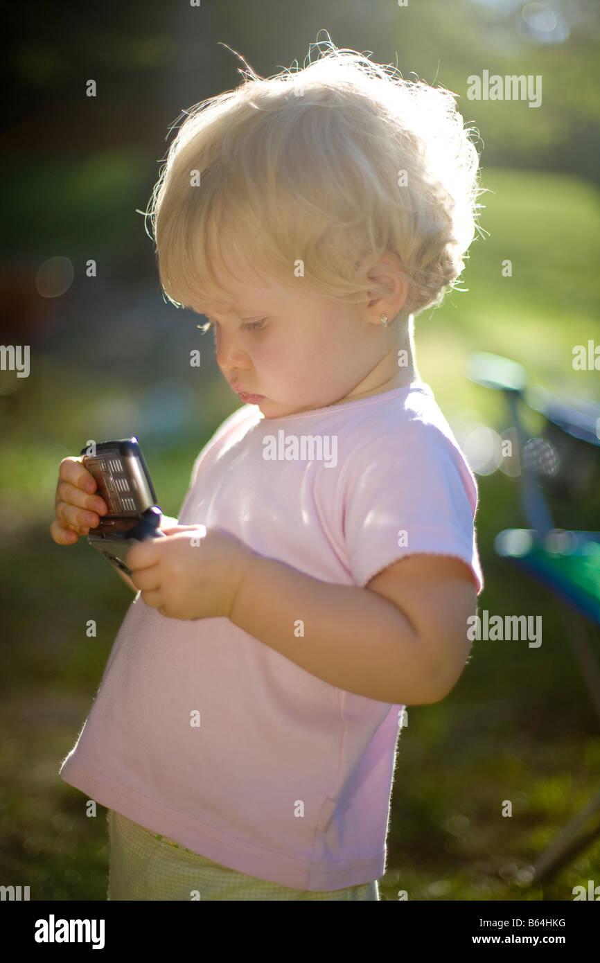Baby girl playing with cell phone Stock Photo - Alamy