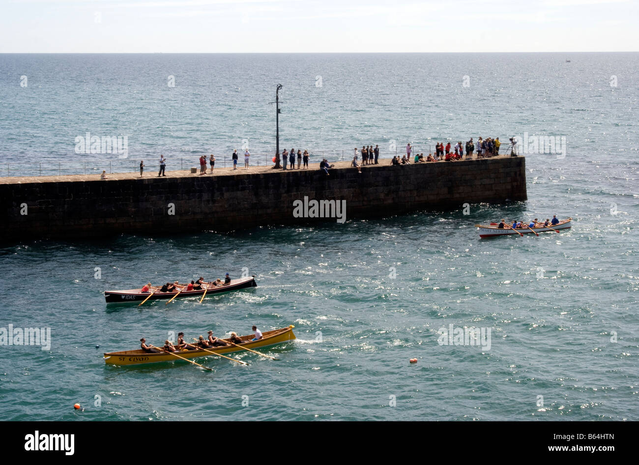 Cornish pilot gigs leave the harbour of Porthleven during a gig-race ...