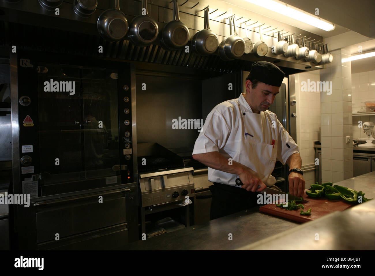 a chef cooking in a kitchen Stock Photo - Alamy