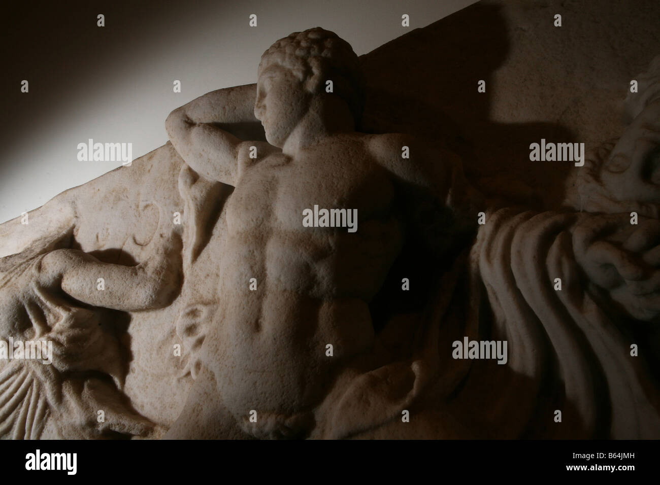 a traditional greek statue taken dramatically on a wall in a house ...