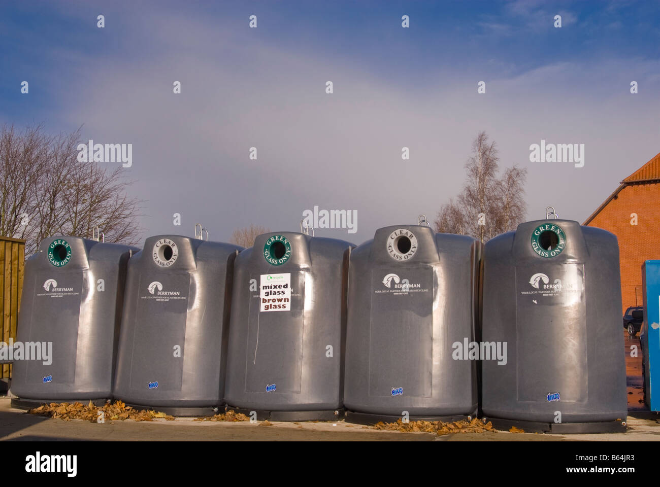 A row of bottle banks for recycling green and clear glass in the uk ...