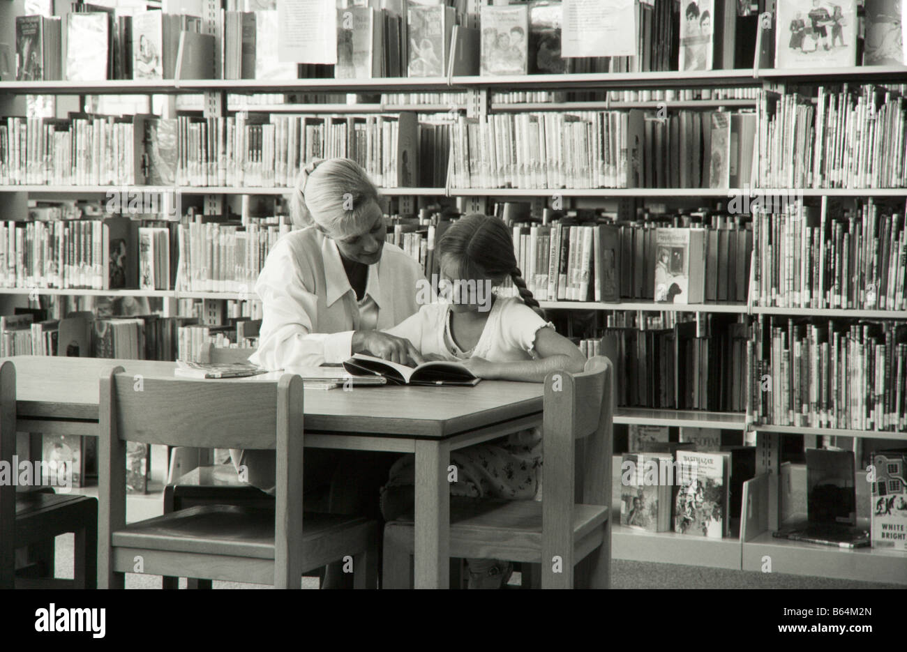 Teacher smiling children in library High Resolution Stock Photography ...