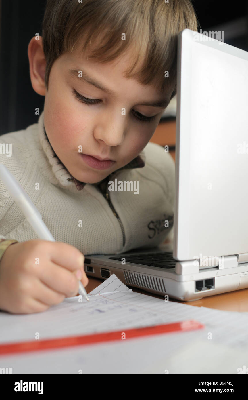 Schoolboy working on his homework Stock Photo - Alamy