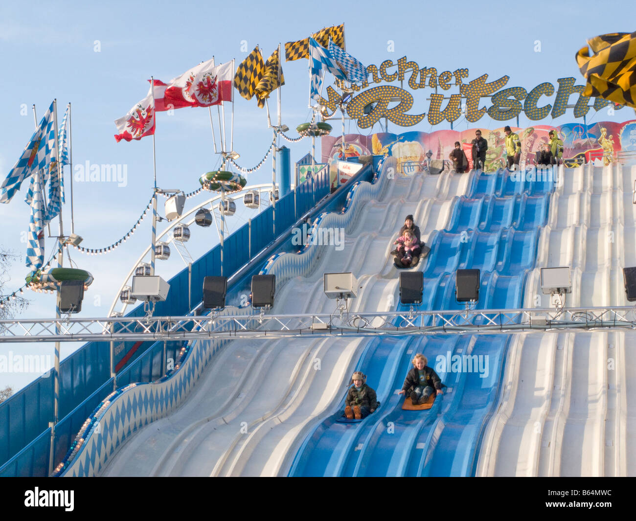 UK. Enjoying the big slide at Christmas Market in Hyde Park, London ...