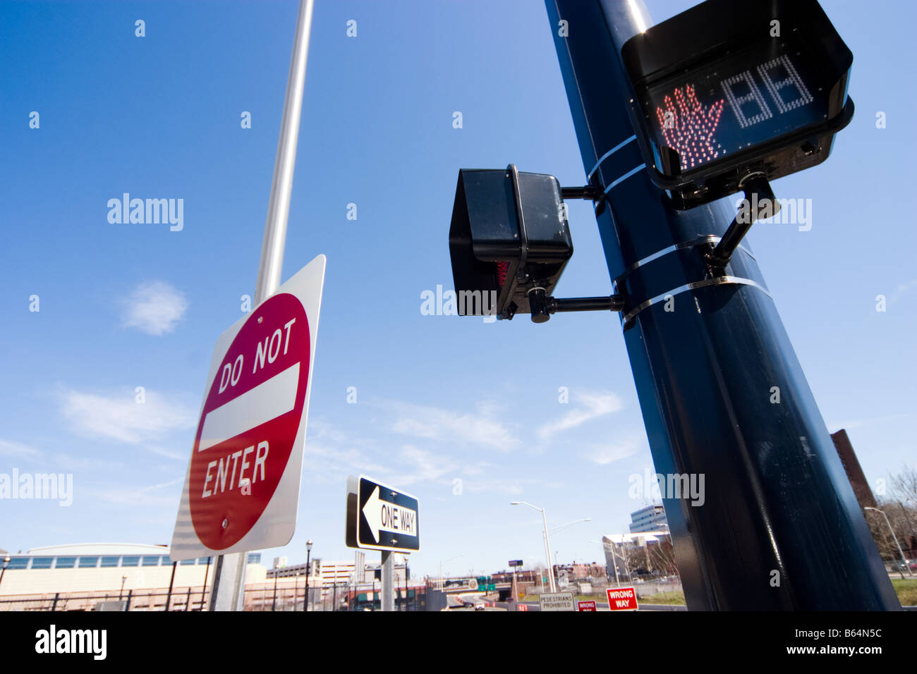 Two traffic signs reading One Way and Do Not Enter and a Walk Do Not ...