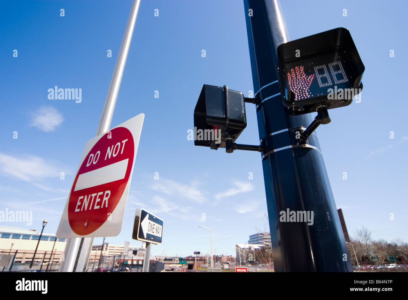 Two traffic signs reading One Way and Do Not Enter and a Walk Do Not ...