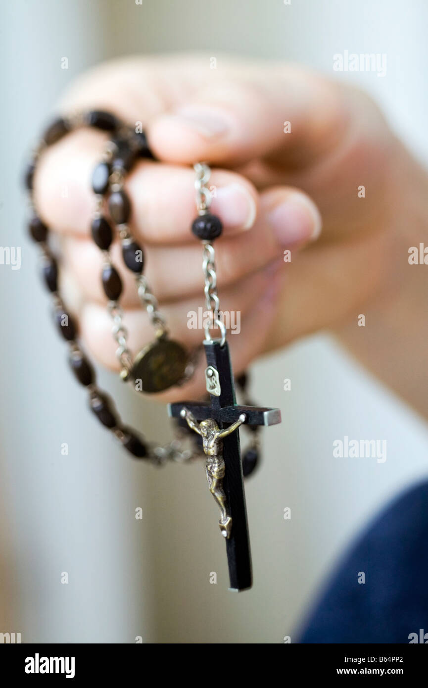 close up of a 28 year old woman's hand holding a rosary Stock Photo - Alamy