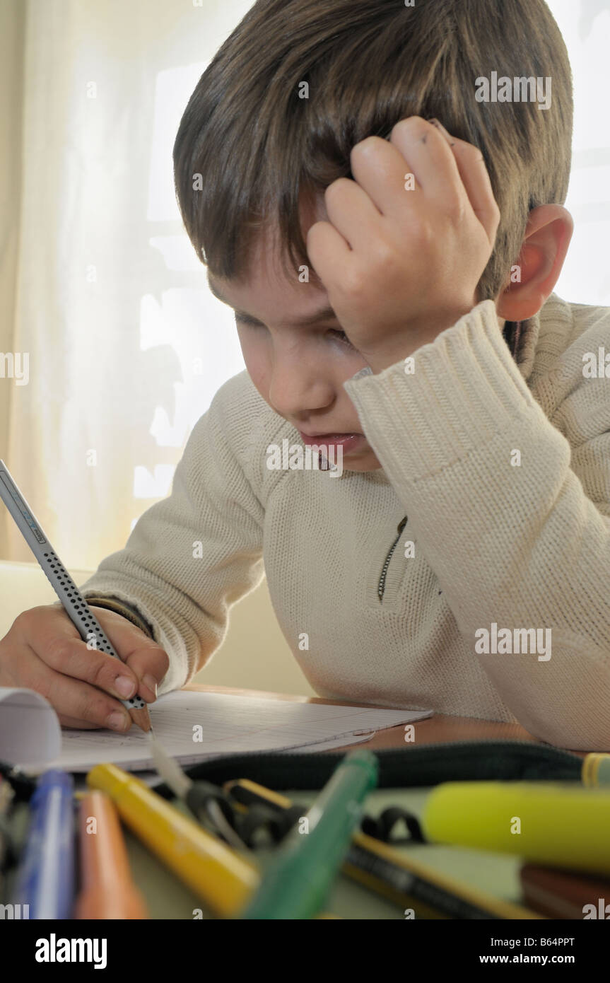 7 years old blond boy working on his homework Stock Photo - Alamy