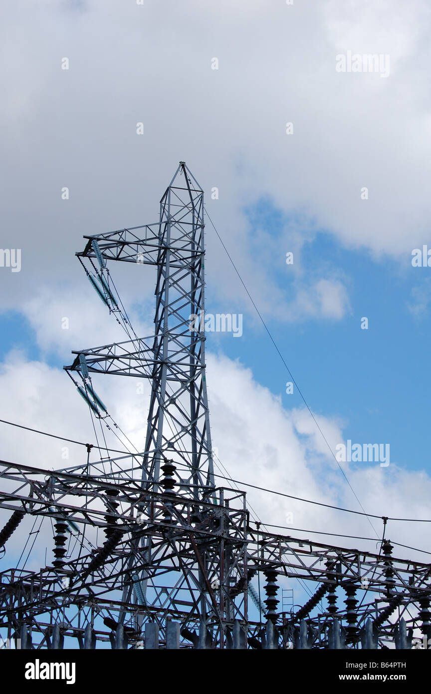 Electricity distribution pylon against broken cloud sky Stock Photo - Alamy