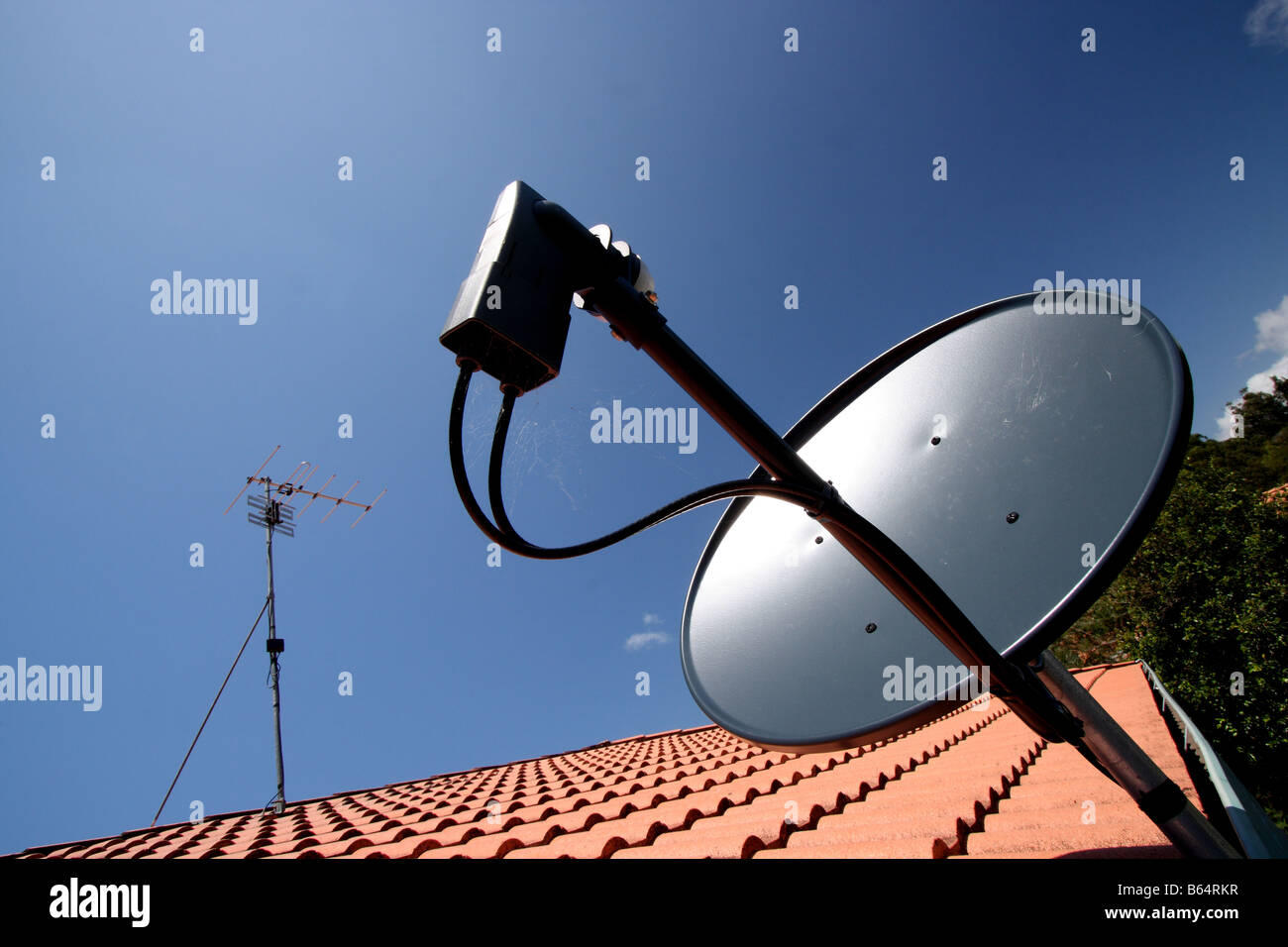 A DOMESTIC SATELLITE DISH MOUNTED ON A HOUSE ROOF HORIZONTAL BDB11159 ...