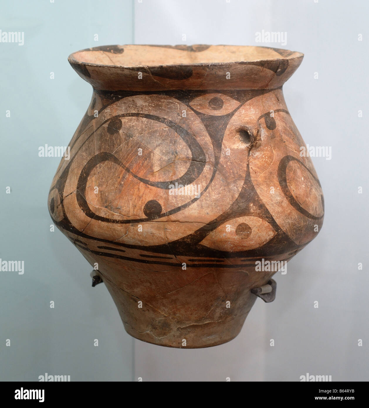 Ancient clay jug with black ornamental pattern and accessories ...