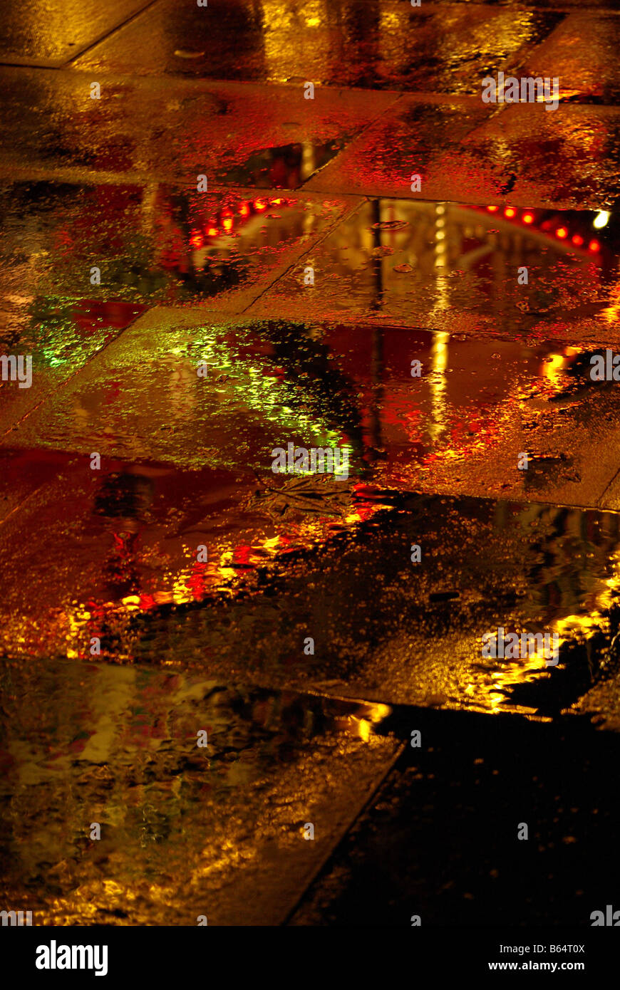 Coloured reflection on a wet pavement Stock Photo - Alamy