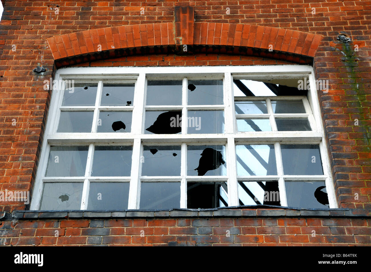 Broken windows of a derelict Victorian factory waiting refurbishment ...