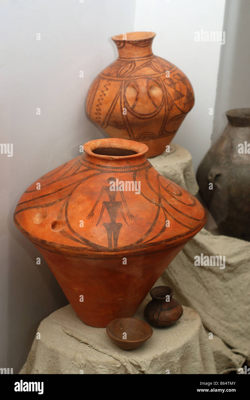 Exposition of very old clay jugs with black ornamental pattern and ...