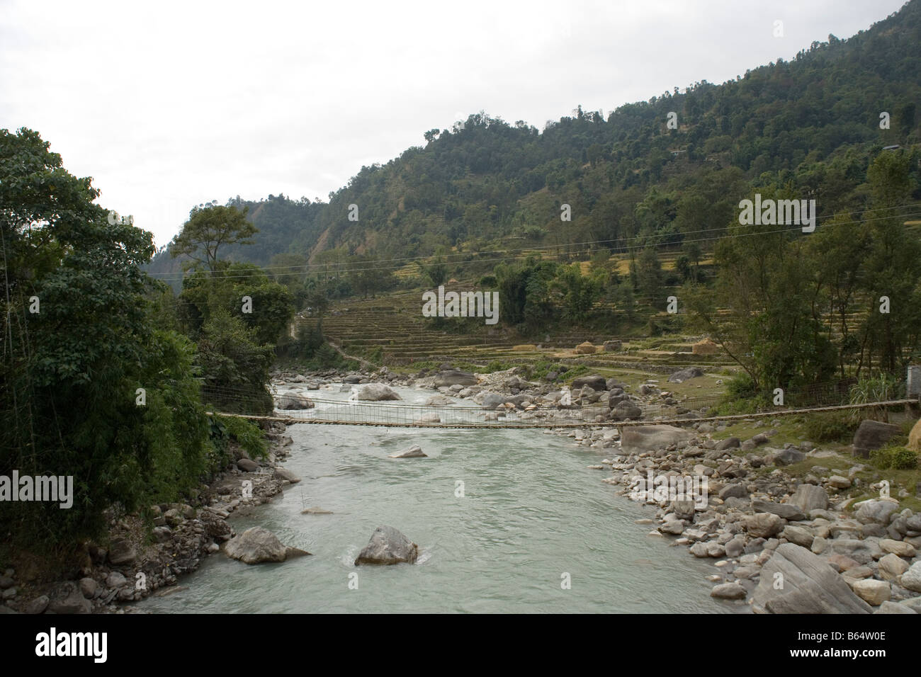 A rope bridge crossing the Modi River in the Annapurna range of the ...