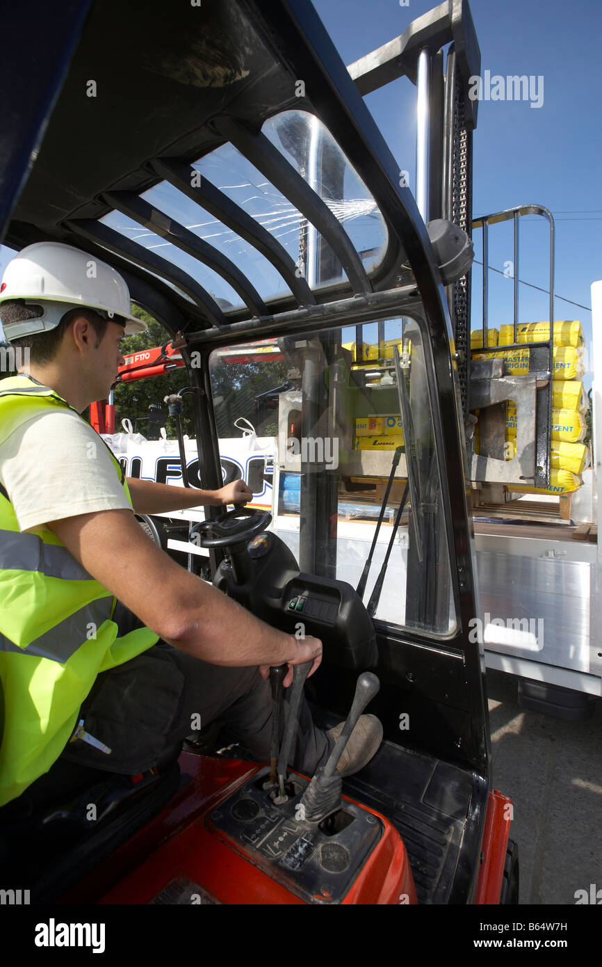 Construction Worker operating Crane and Fork Lift Stock Photo - Alamy