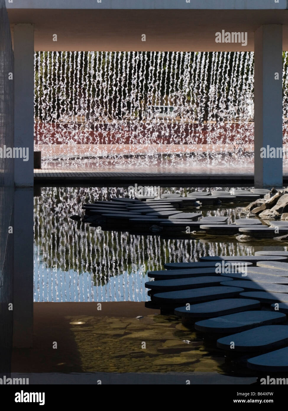 Waterfall cascade fountain and reflecting pool with stepping stones ...